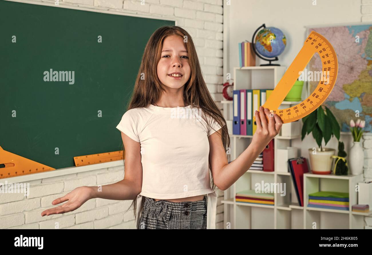 girl in classroom school with protractor math tool ruler, geometry ...