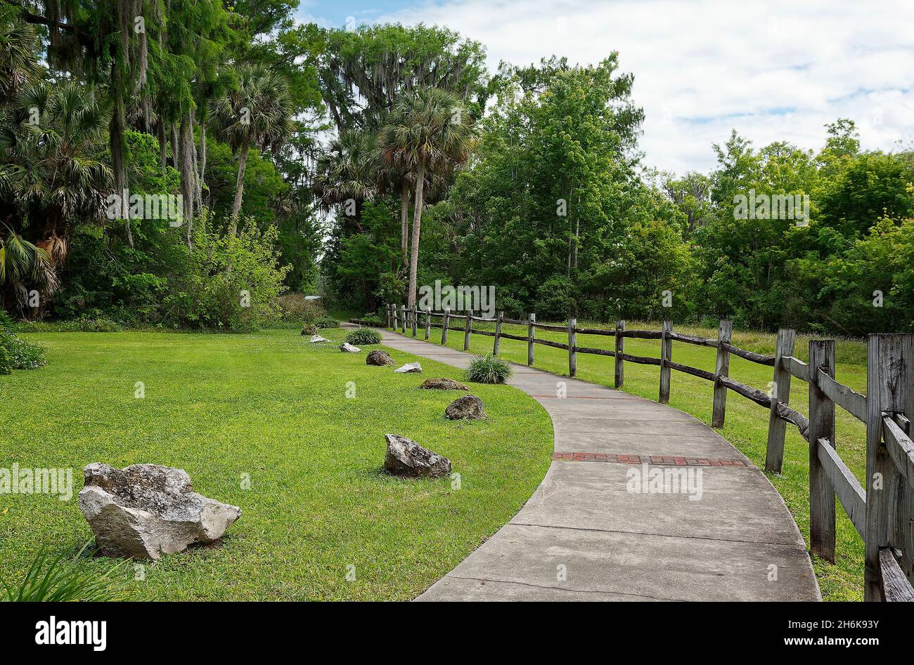 walking path, cement, split rail fence, grass, trees, rocks, recreation ...