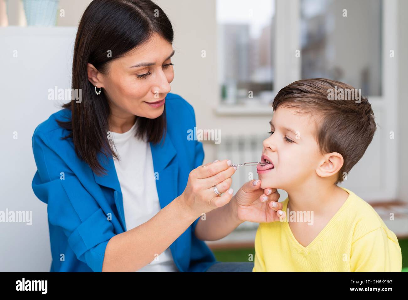 Woman develops the language of the child with a speech therapy probe ...
