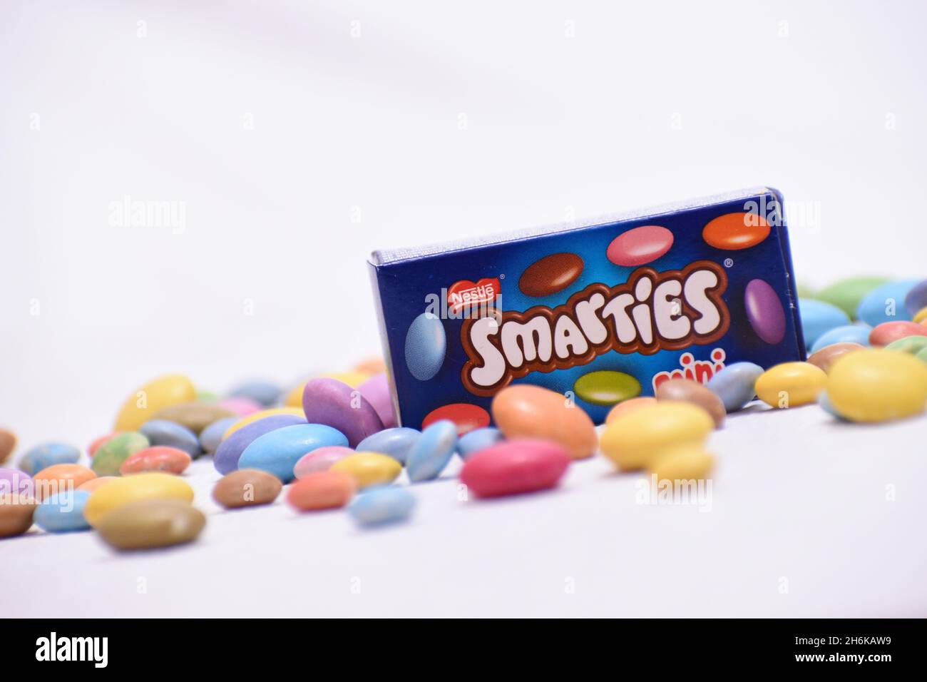A box of colorful Smarties surrounded by candy, manufactured by Nestlé ...