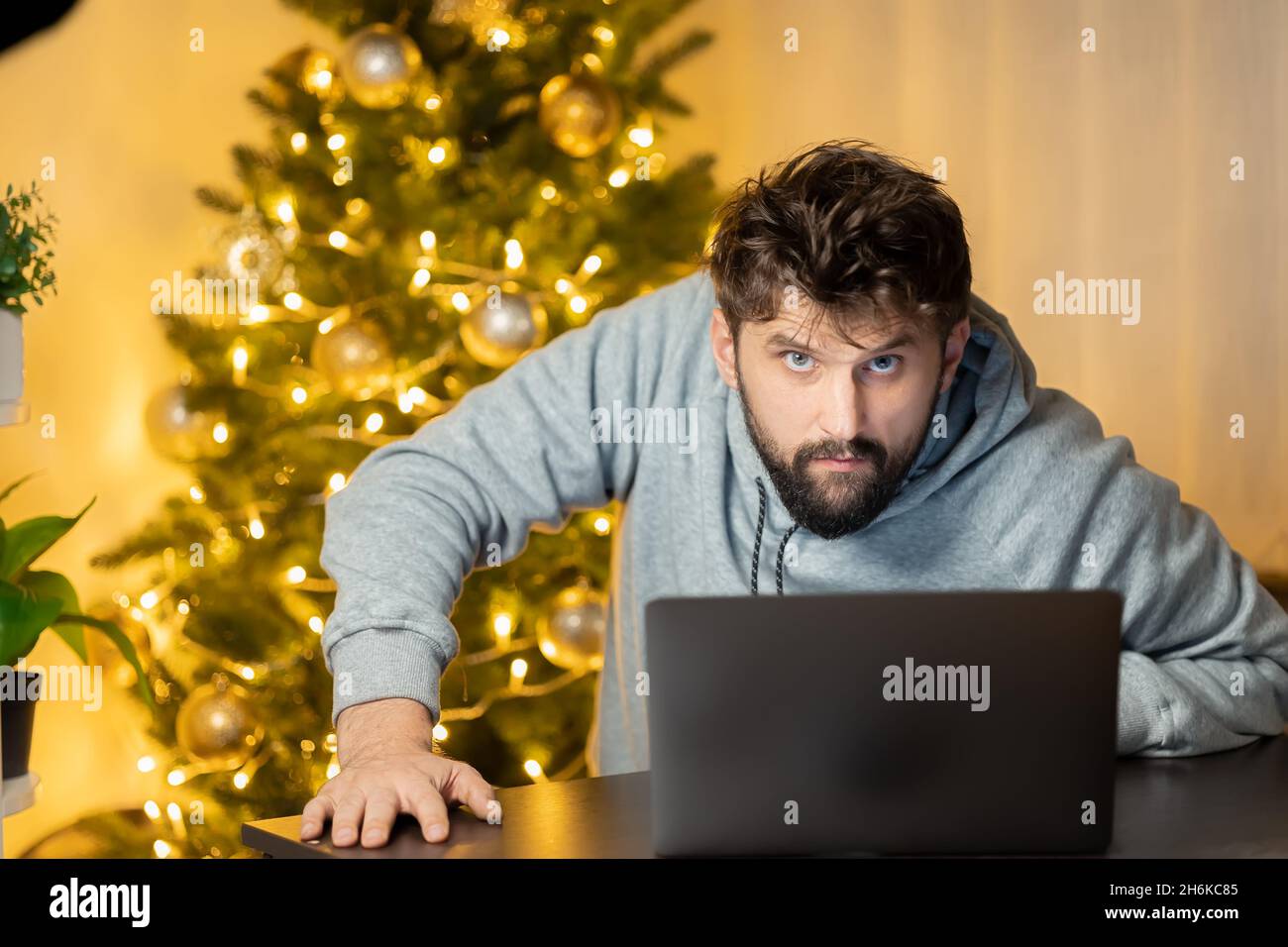 on the night before christmas, the tortured man works at the laptop in ...