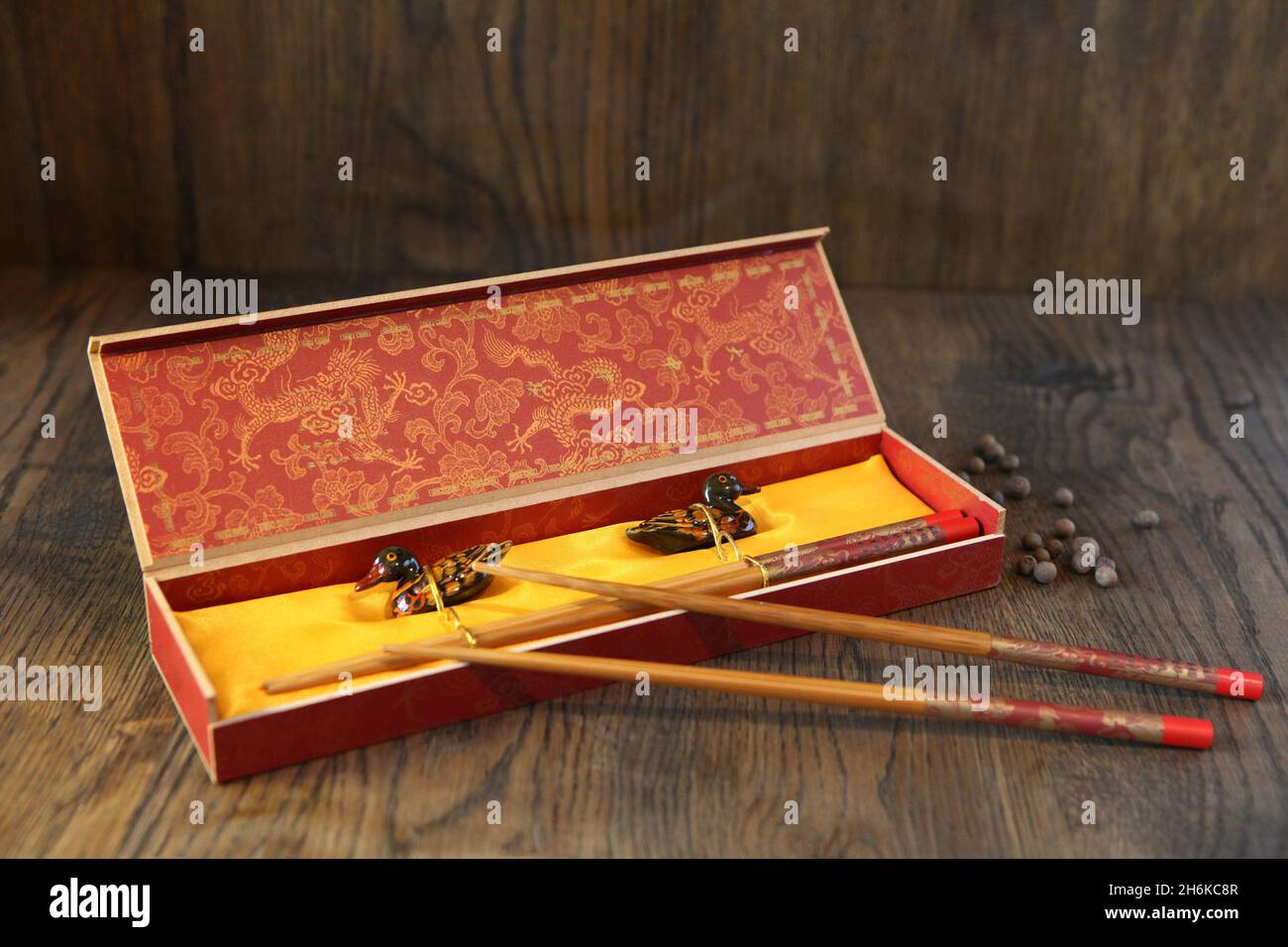 chopsticks and rest in the traditional box on dark oak wooden table ...