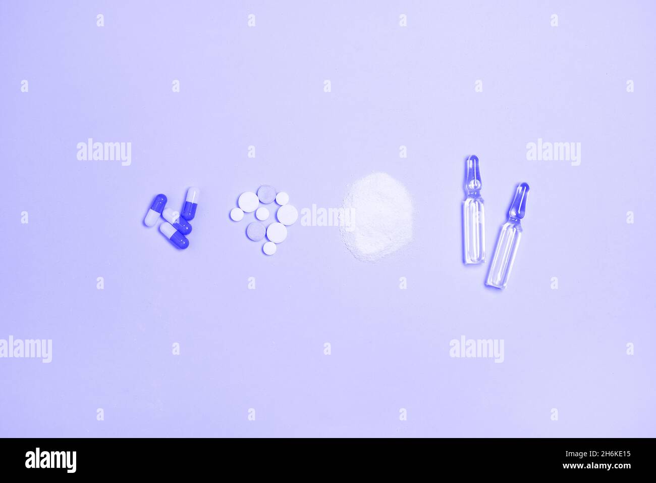 Different medications as a pills, ampule injections and powder on lilac ...