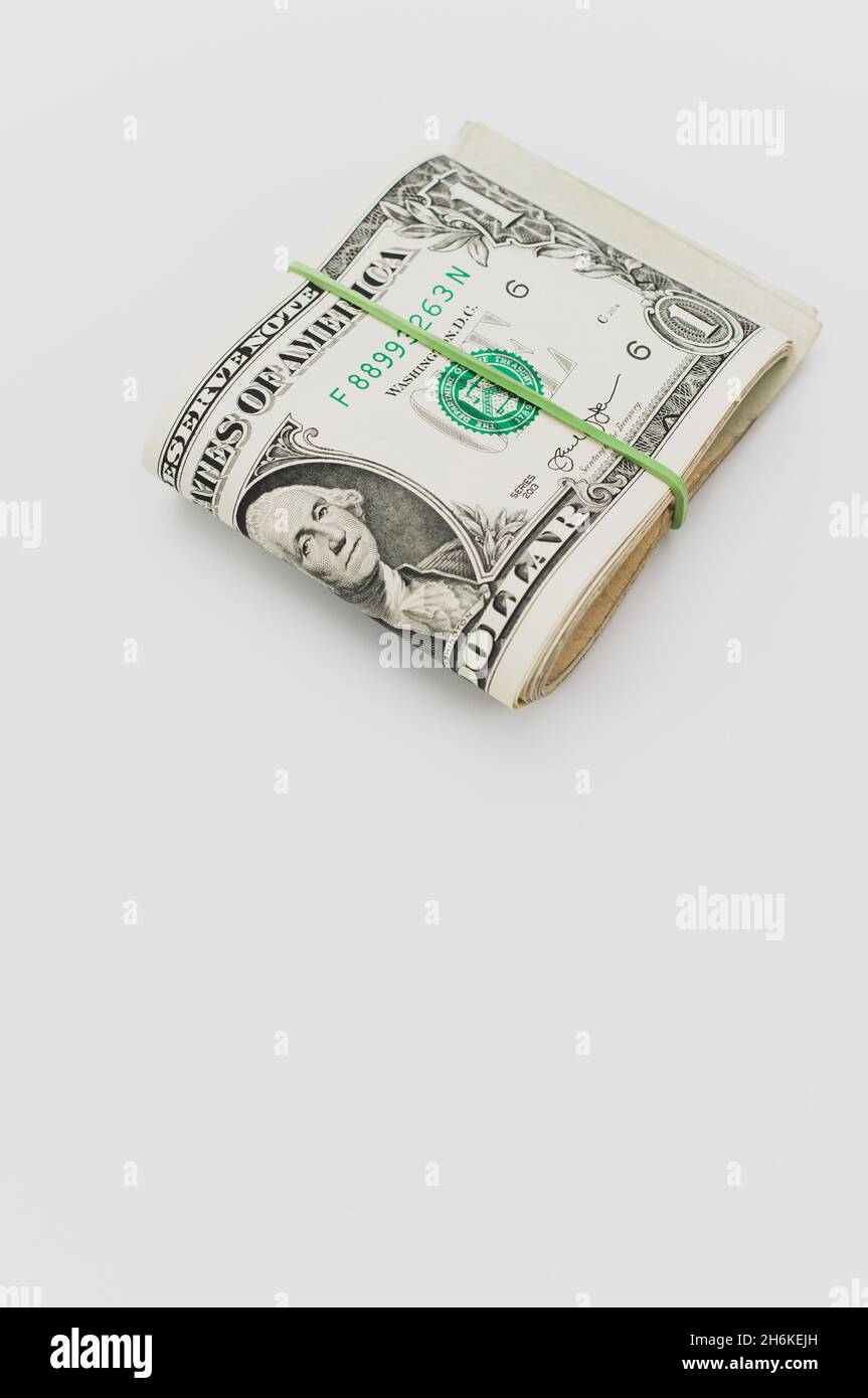 isolated US dollar banknotes wad on a white background with copy space ...