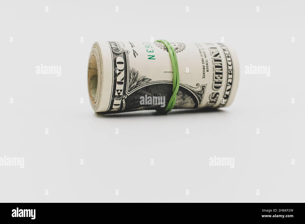 isolated US dollar banknotes roll on a white background with copy space ...