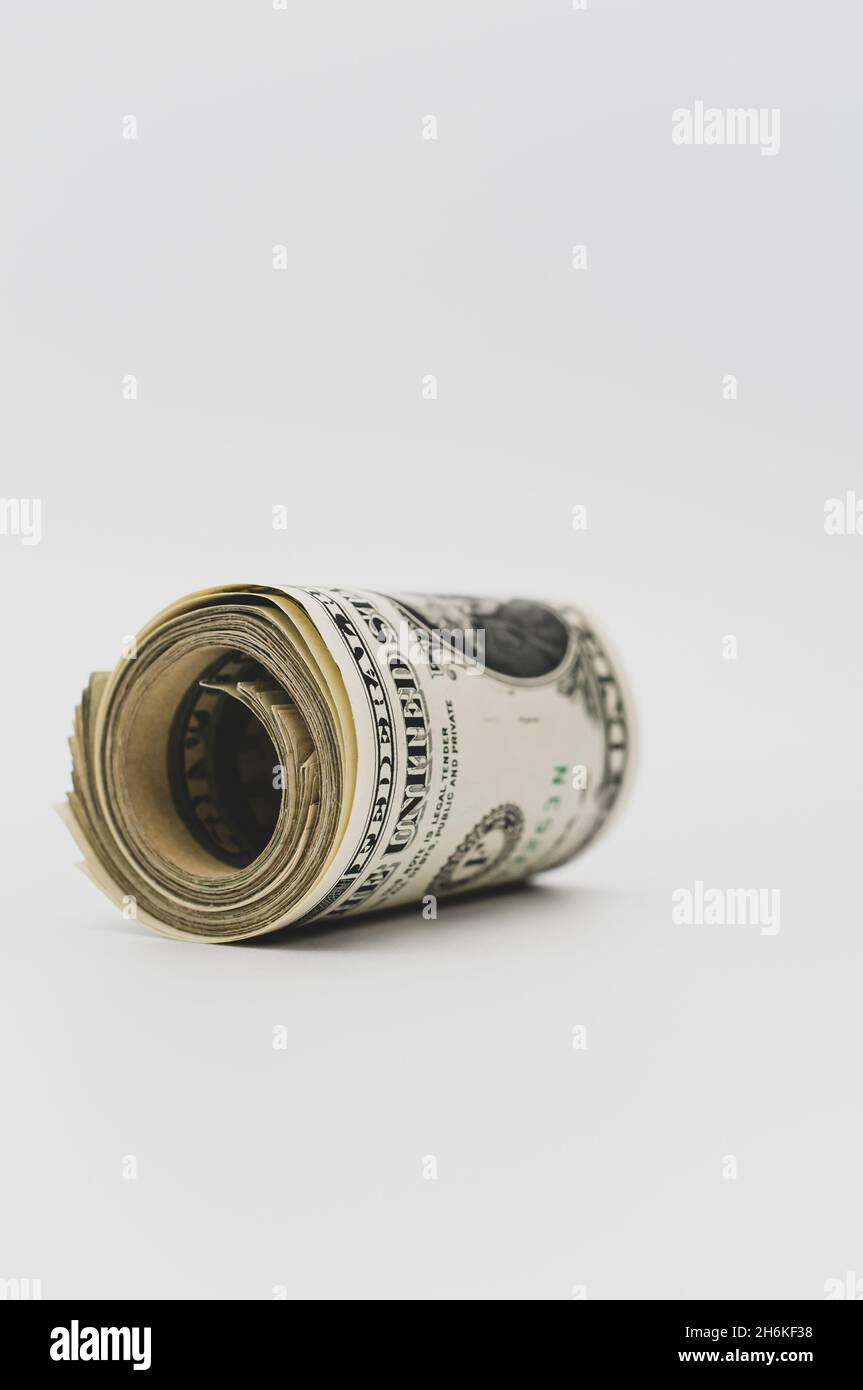 isolated US dollar banknotes roll on a white background with copy space ...