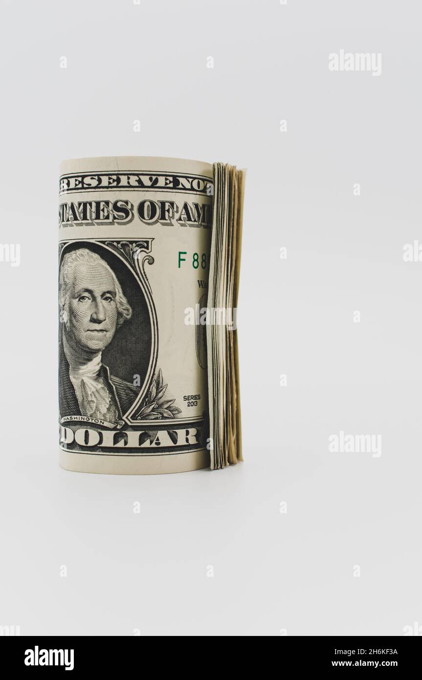 isolated US dollar banknotes roll on a white background with copy space ...