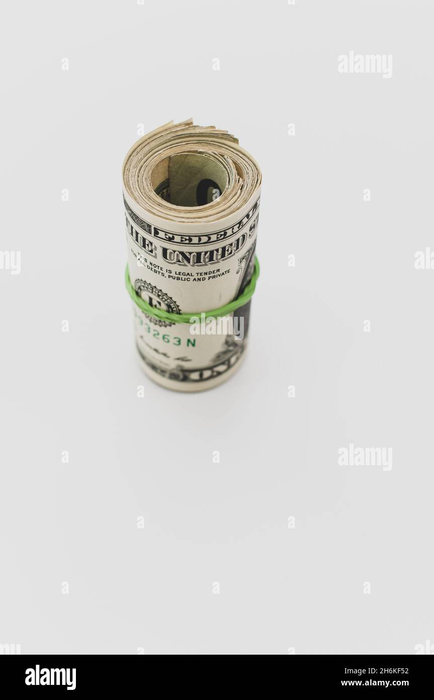 isolated US dollar banknotes roll on a white background with copy space ...