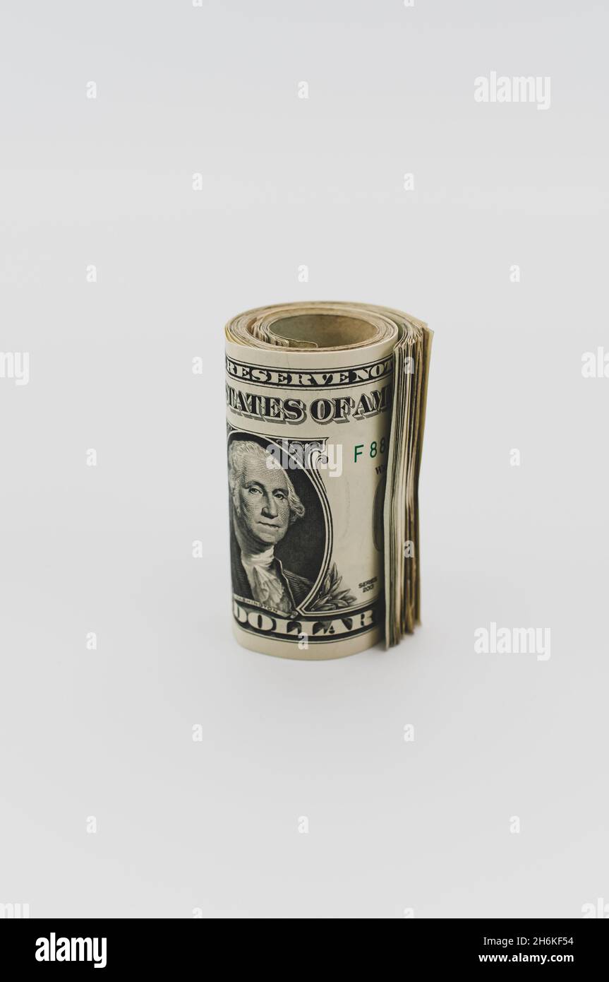 isolated US dollar banknotes roll on a white background with copy space ...