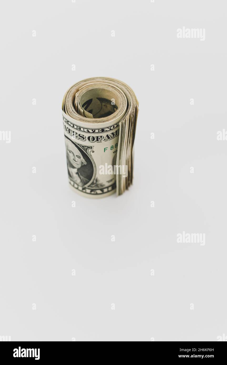 isolated US dollar banknotes roll on a white background with copy space ...