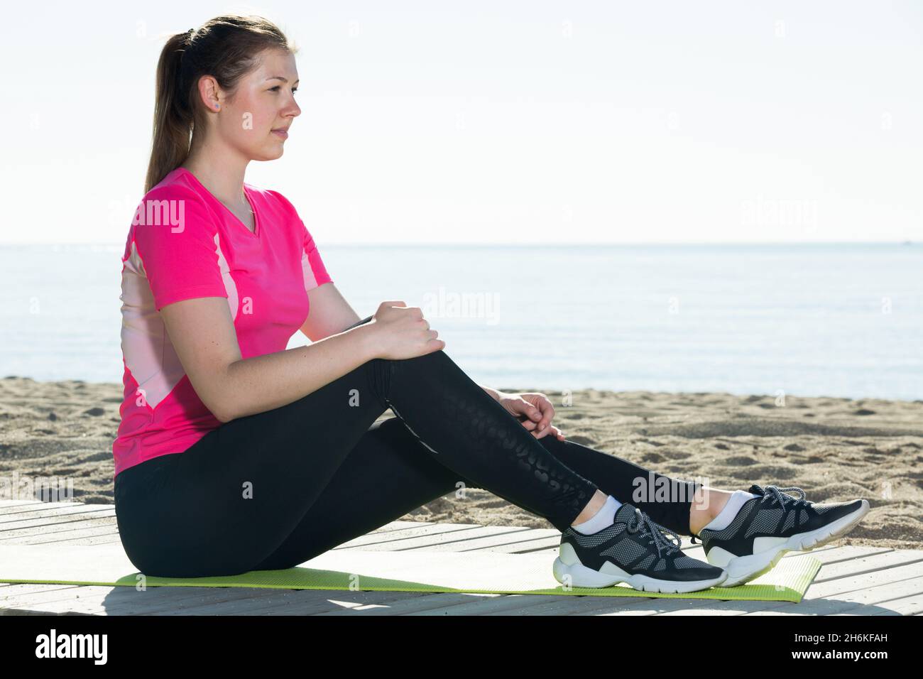 Woman relaxing after workout outdoors Stock Photo - Alamy