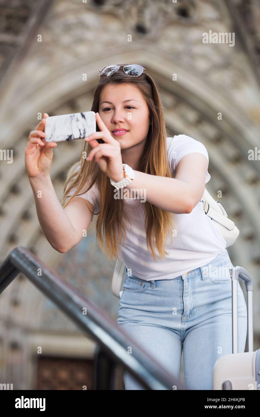 Girl holding phone and photographing Stock Photo - Alamy