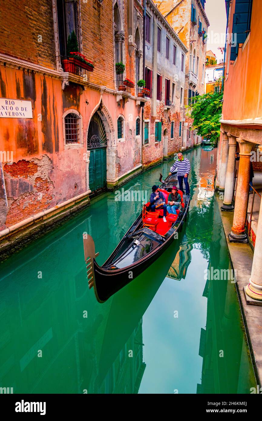 Venice gondola travelling down a pretty narrow canal Venice italy Stock ...