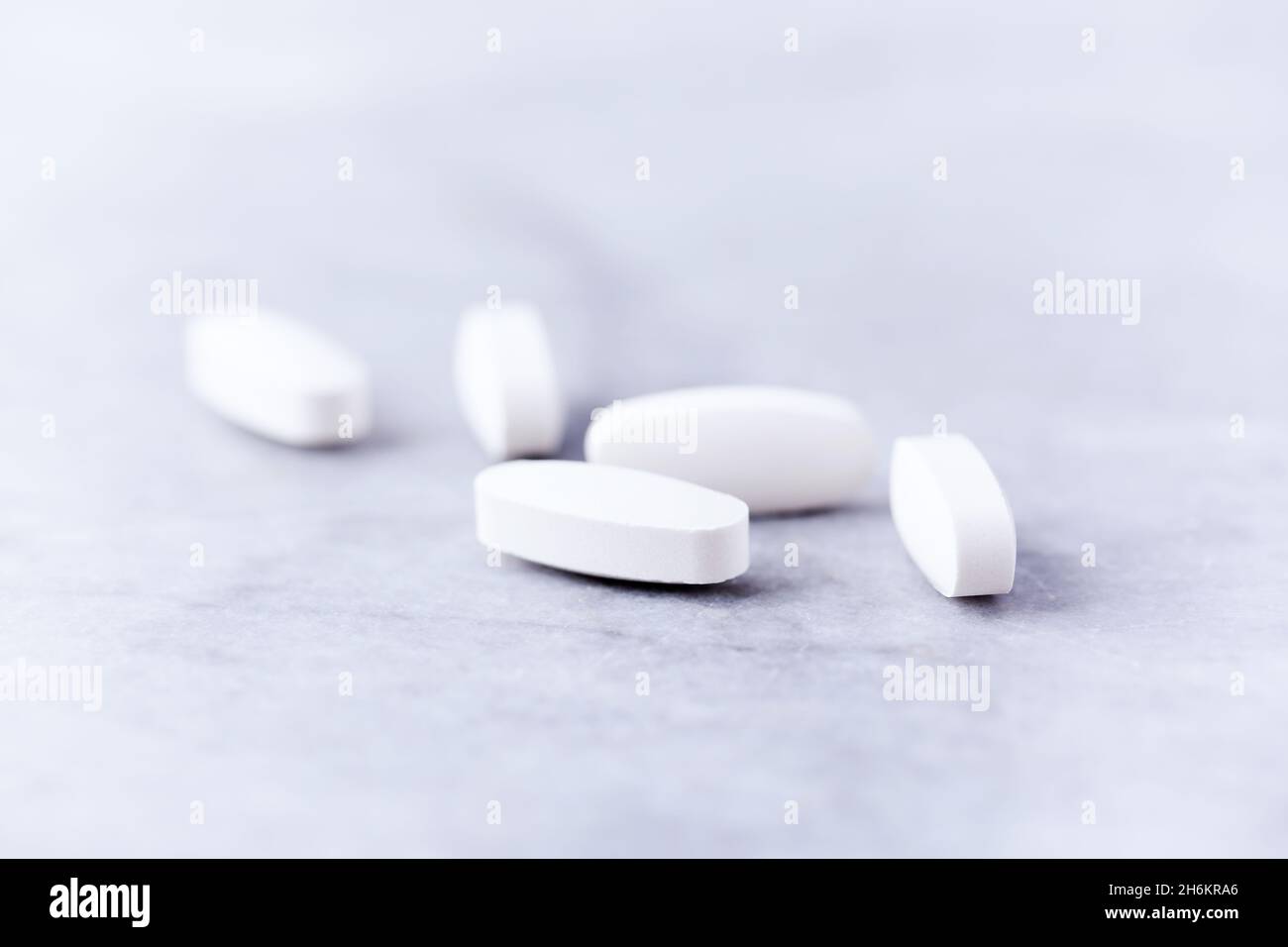 Beta - Alanine tablets. A dietary supplement on bright stone background ...