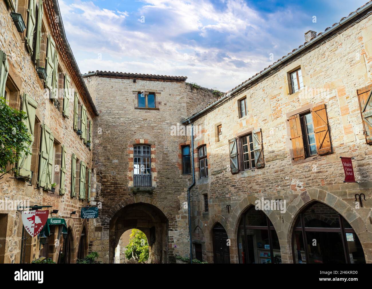 Old street and porch of the medieval village of Cordes sur Ciel, in the ...