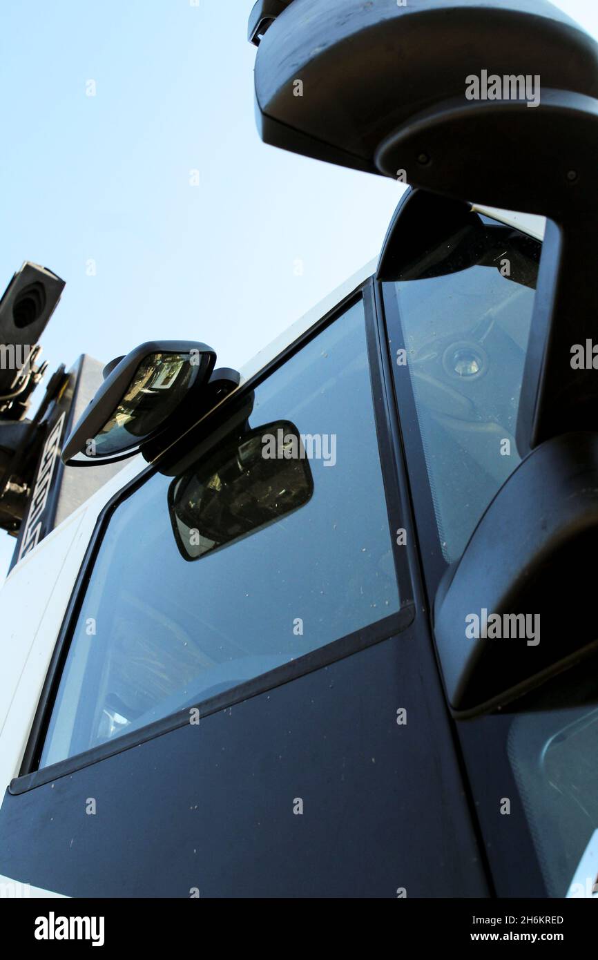 Black cabin of a truck crane with rear-view mirror Stock Photo - Alamy