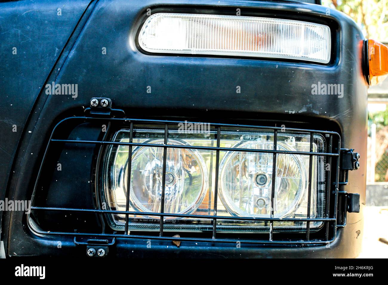 Headlights of oversize truck and black bodywork Stock Photo - Alamy