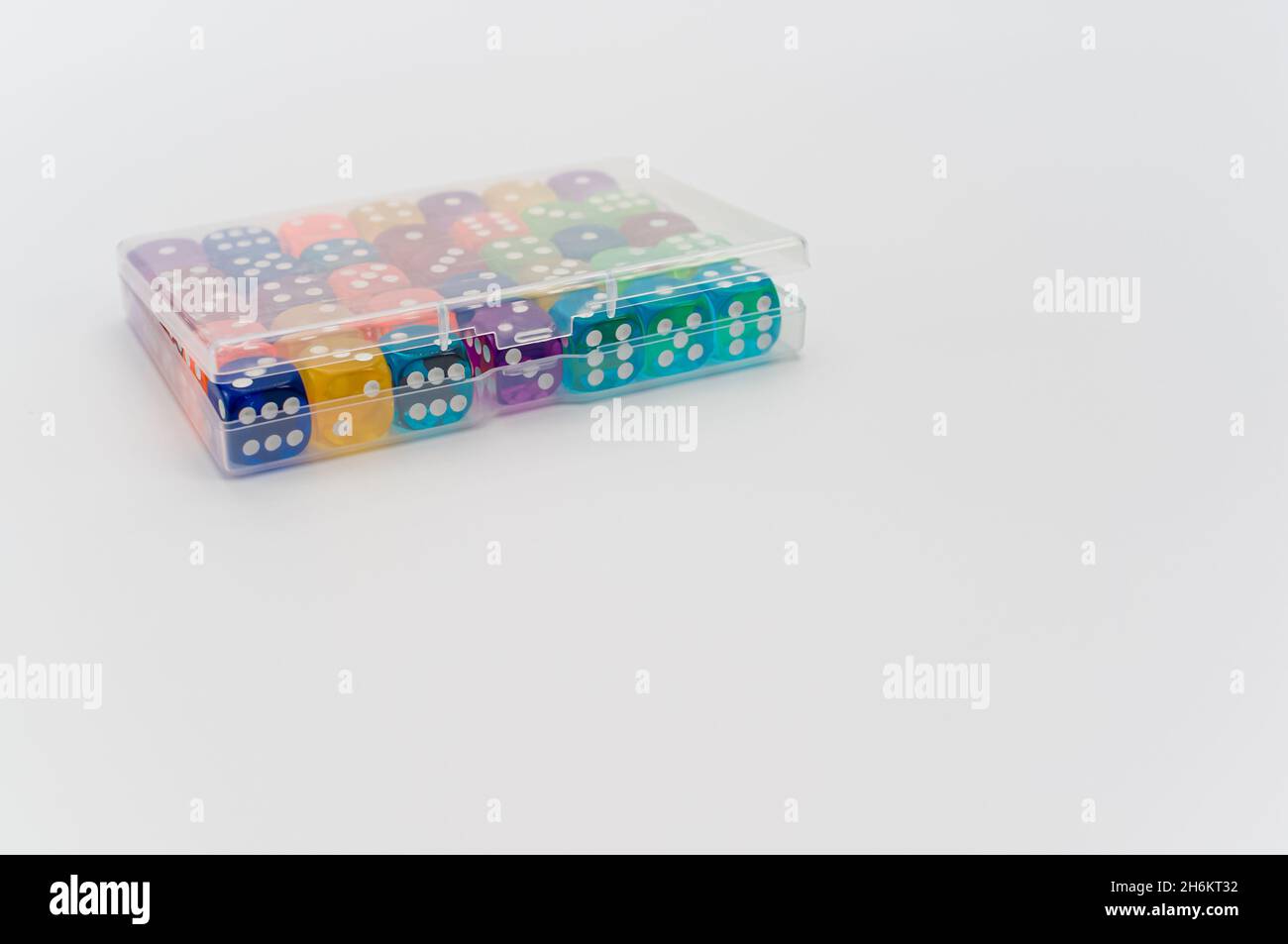 box of multicolored dice on a white background with text space Stock ...