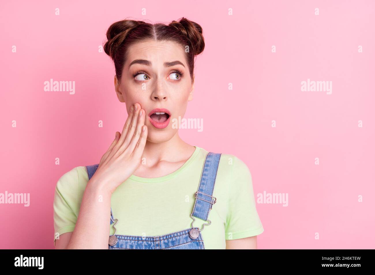 Photo of adorable cute girl look empty space palm cheek wear jeans ...