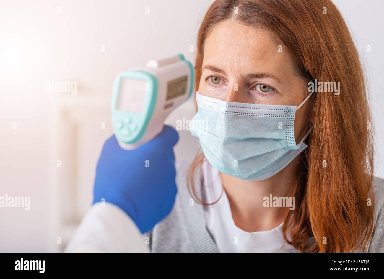 Doctor measuring patient temperature Stock Photo - Alamy