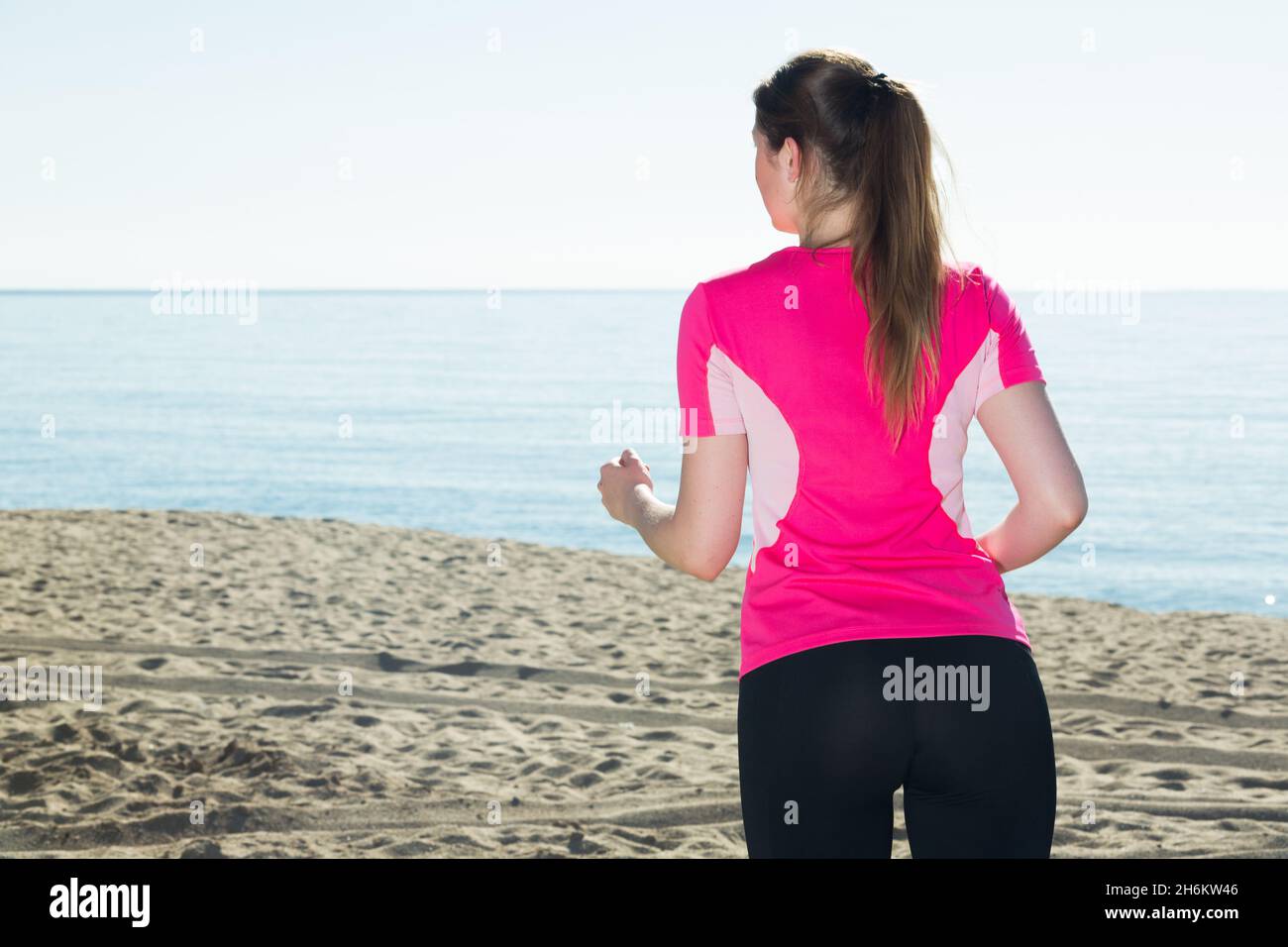 Svelte woman jogging on beach Stock Photo - Alamy