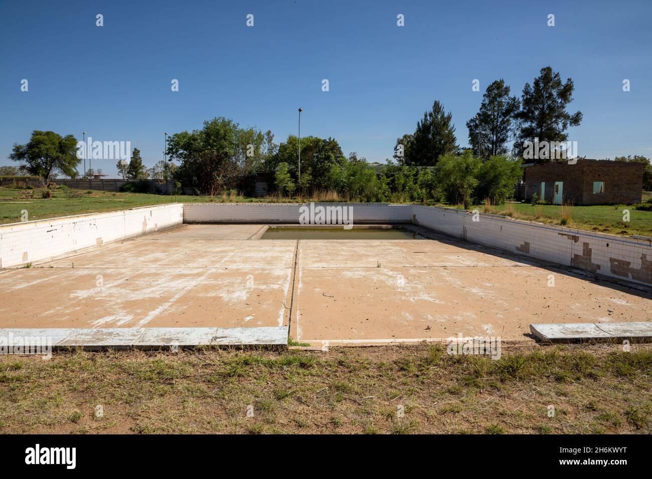 Abandoned swimming pool with large concrete slabs that are exposed ...