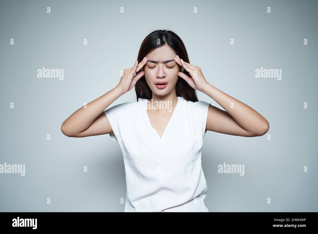 beautiful woman holding her head because of dizziness Stock Photo - Alamy