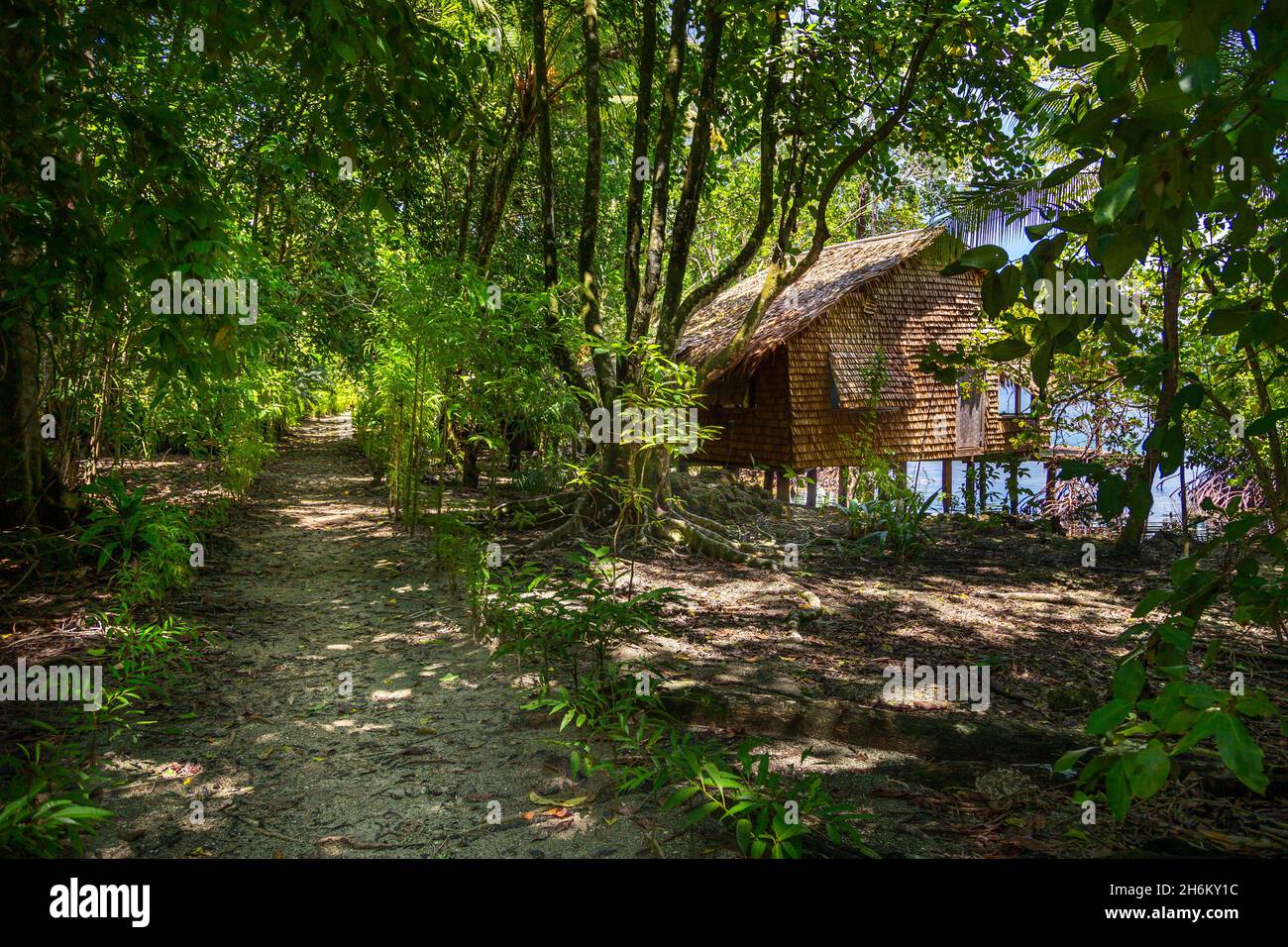 Waterfront thatched hut in the rainforests of Marovo Lagoon in the ...