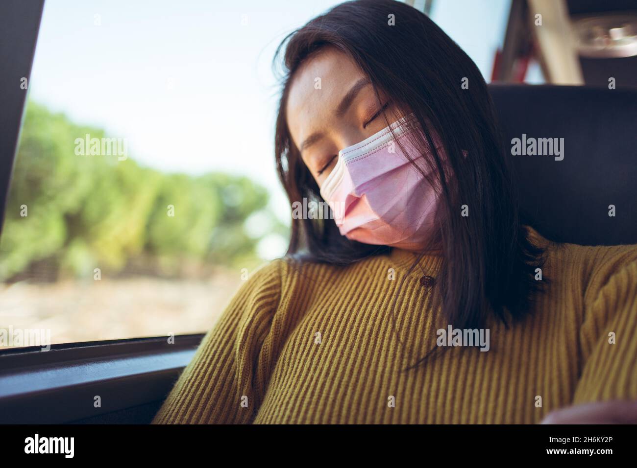 Young Asian pretty woman sleeping while travelling in empty bus with ...