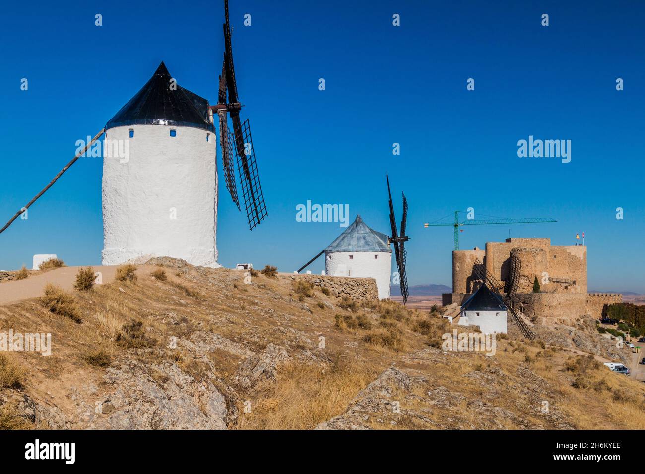 Windmills and castle in Consuegra village, Spain Stock Photo - Alamy