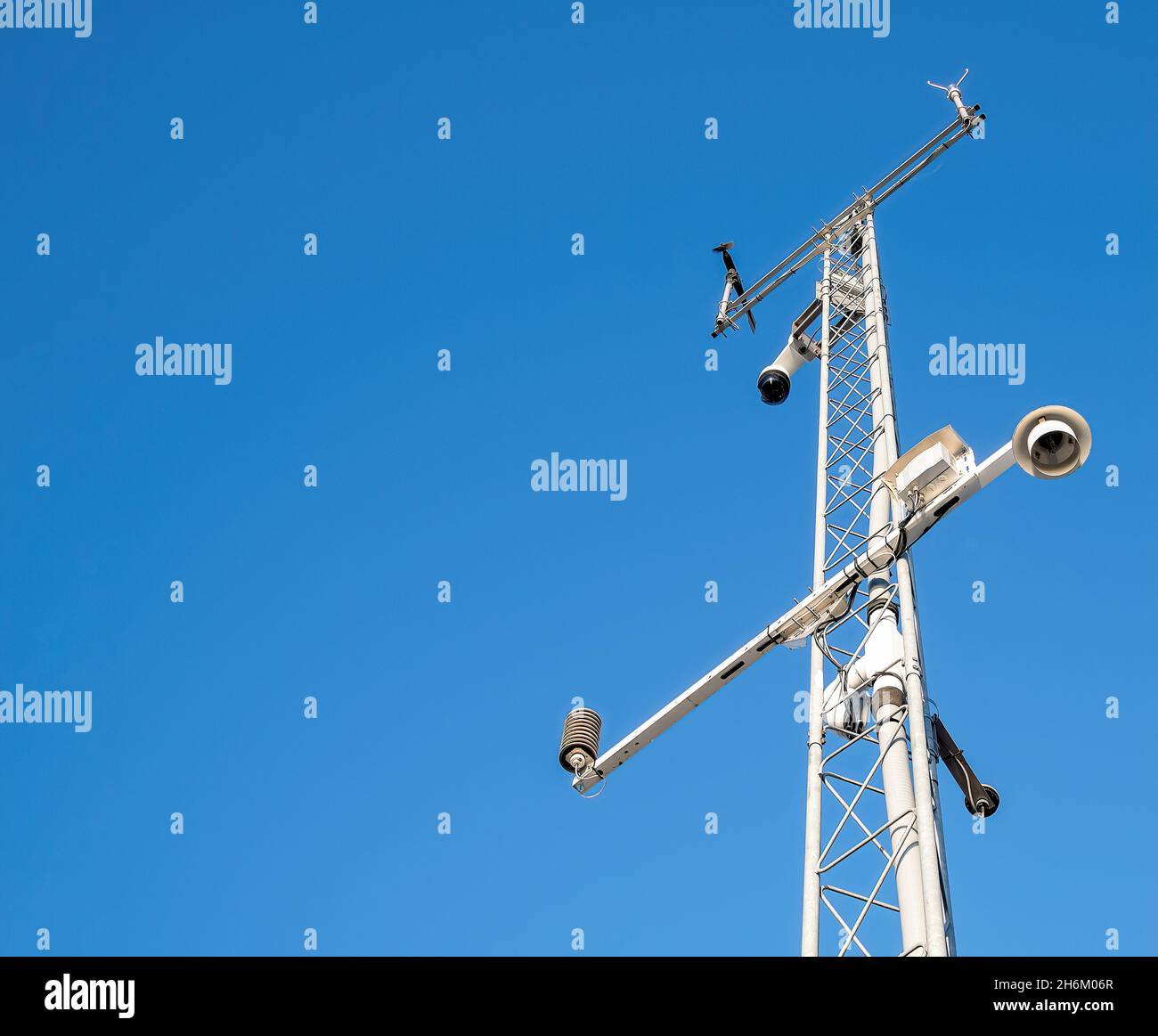Weather station tower on bright blue sky background with modern ...