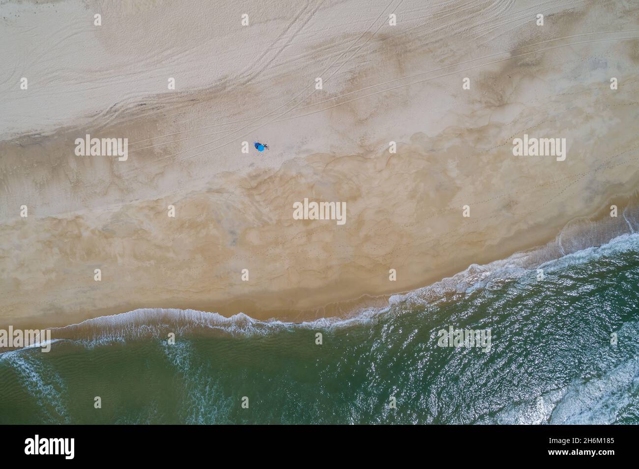 Aerial view of the wavy sea hitting the sandy beach on the coast Stock ...