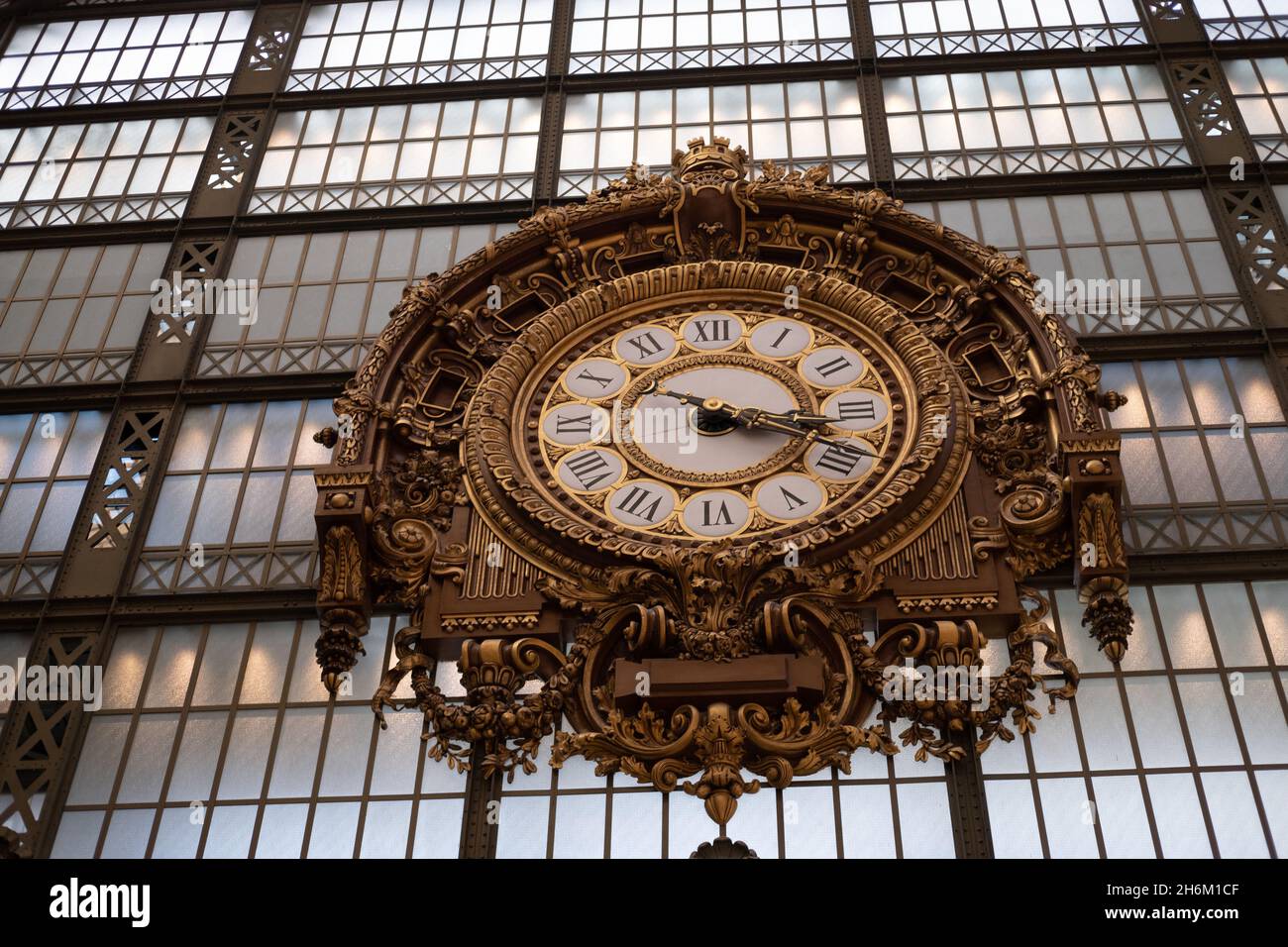 Low angle of the big golden ornamental clock in the Orsay Museum in ...