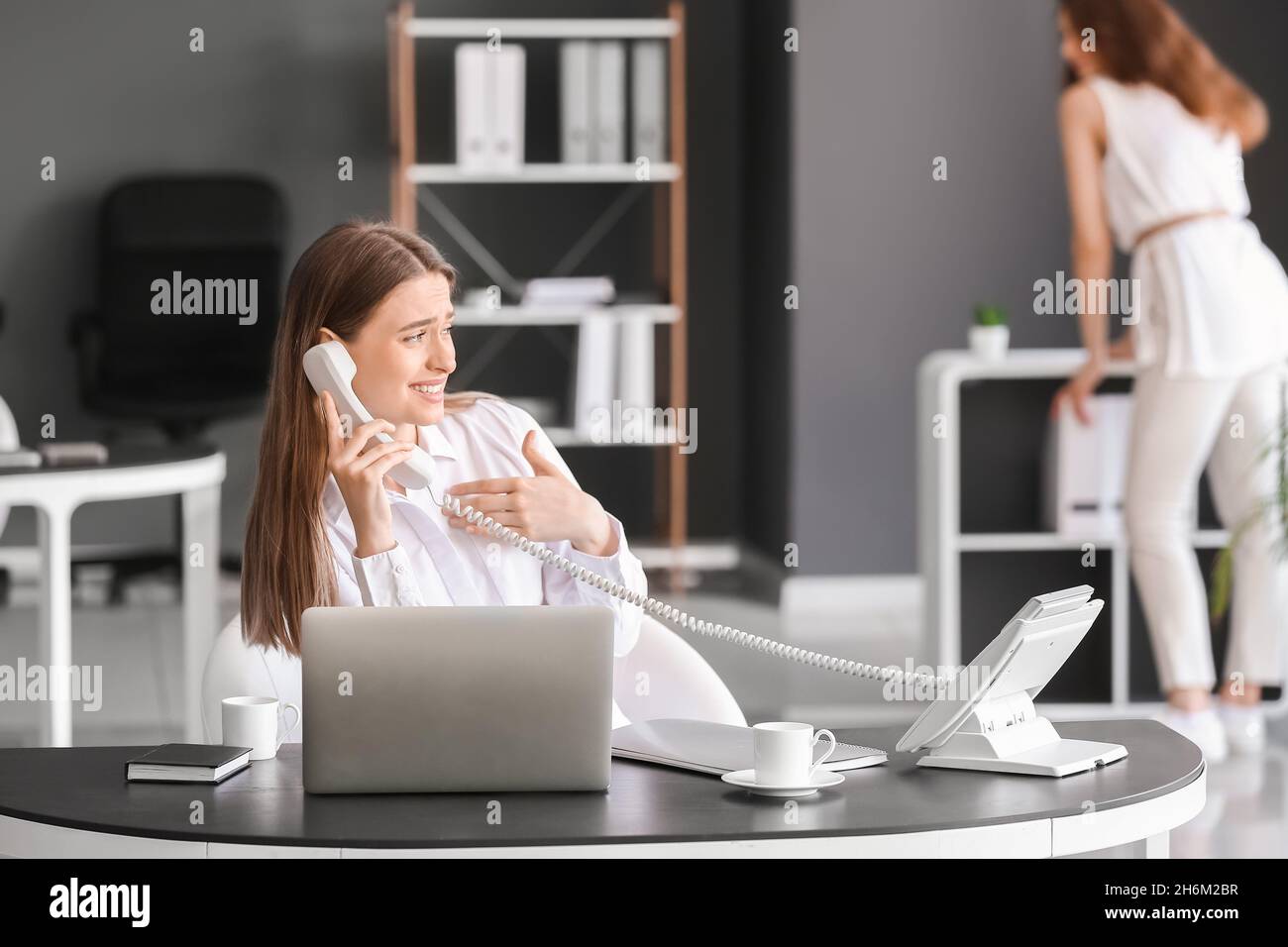 Woman gossiping at work hi-res stock photography and images - Alamy