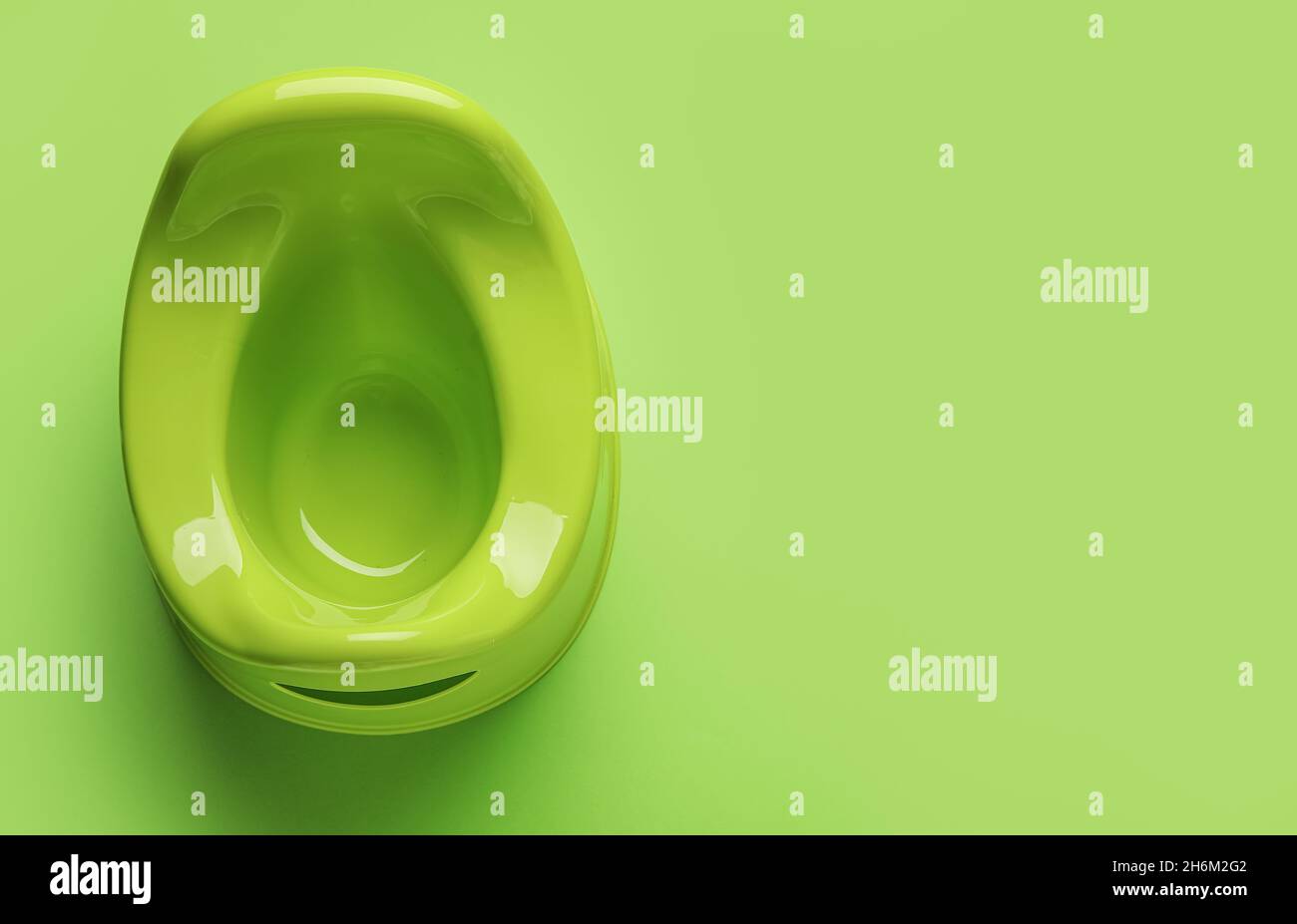 Modern potty on green background Stock Photo - Alamy