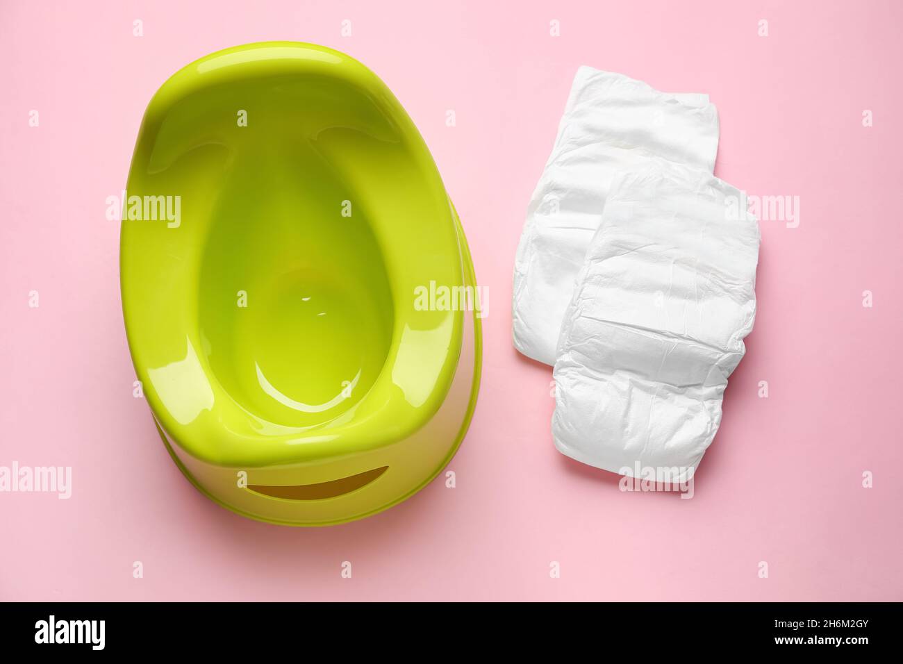 Potty and diapers on color background Stock Photo - Alamy