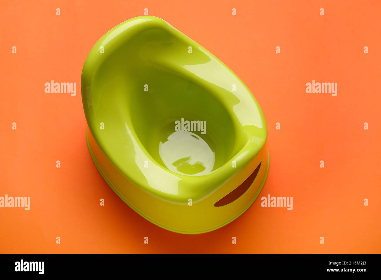 Modern green potty on color background Stock Photo - Alamy
