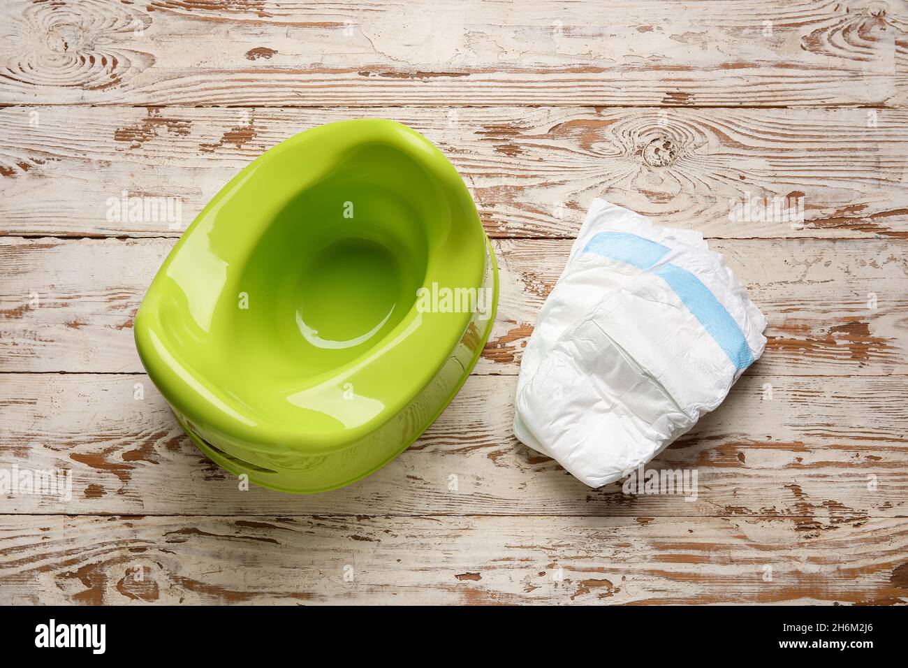 Potty and diapers on wooden background Stock Photo - Alamy