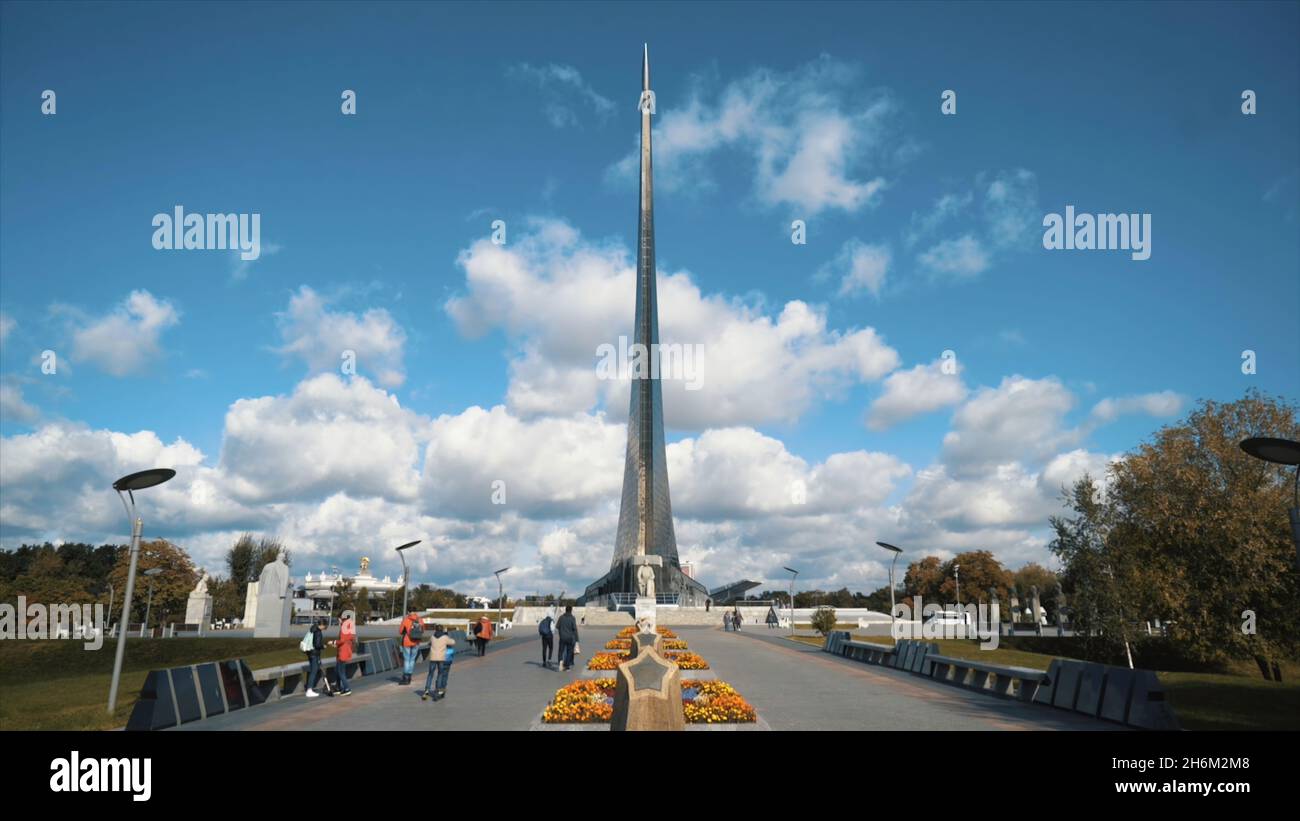 Close-up of people walking near the monument in memory of achievements ...