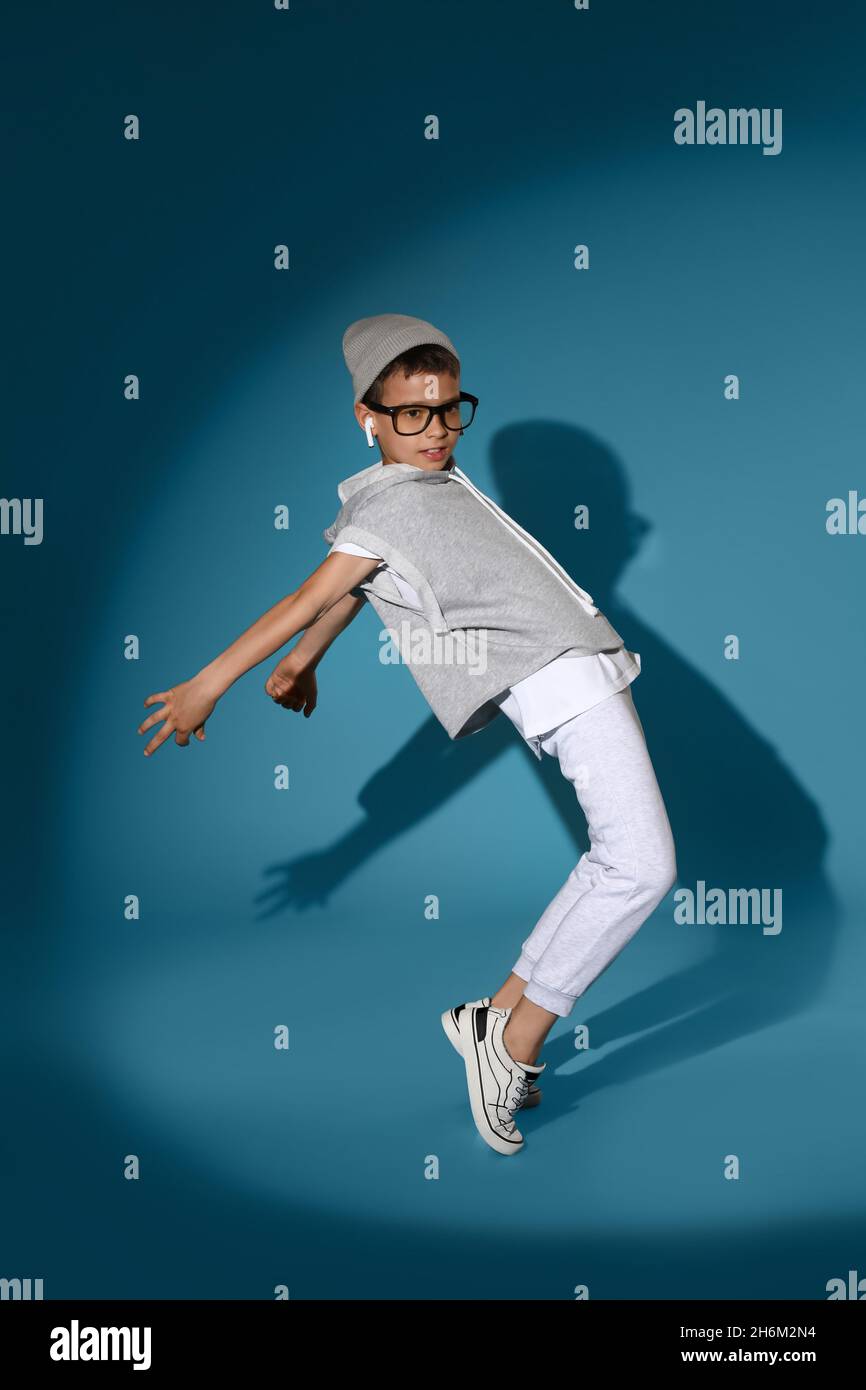Dancing little boy on color background Stock Photo - Alamy