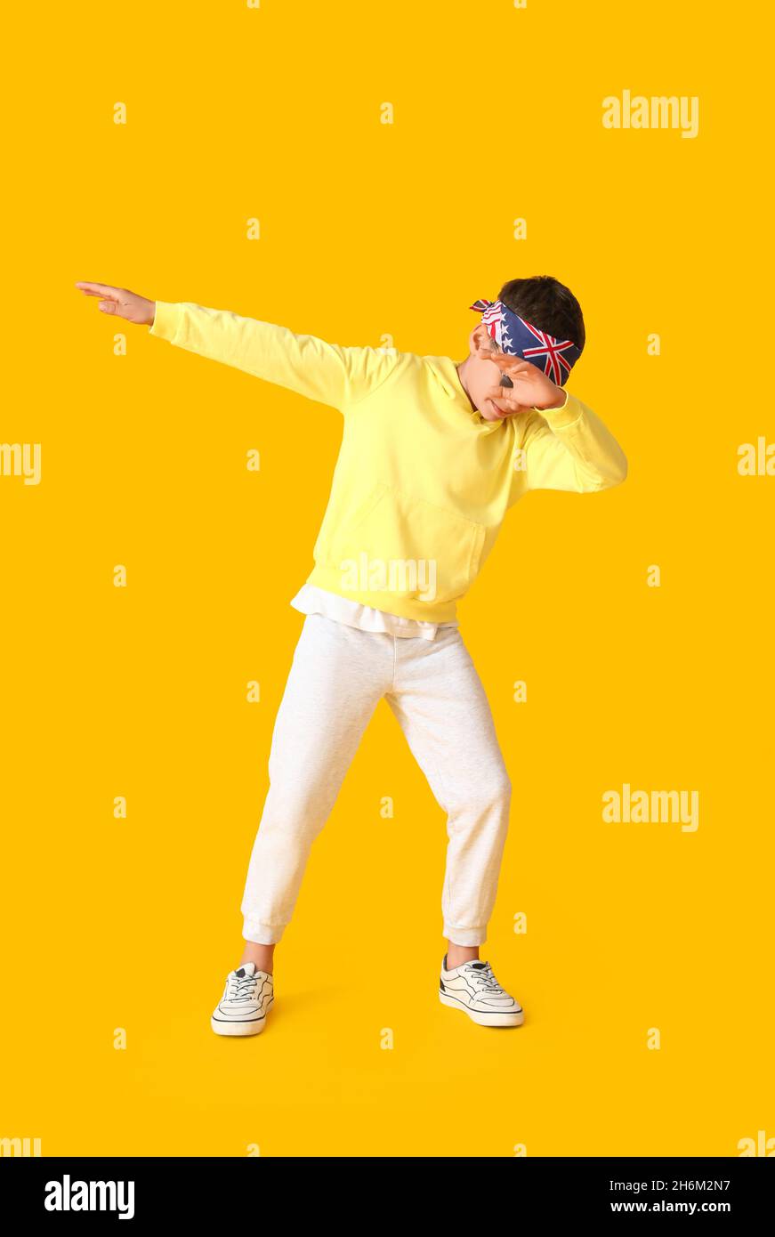 Dancing little boy on color background Stock Photo - Alamy