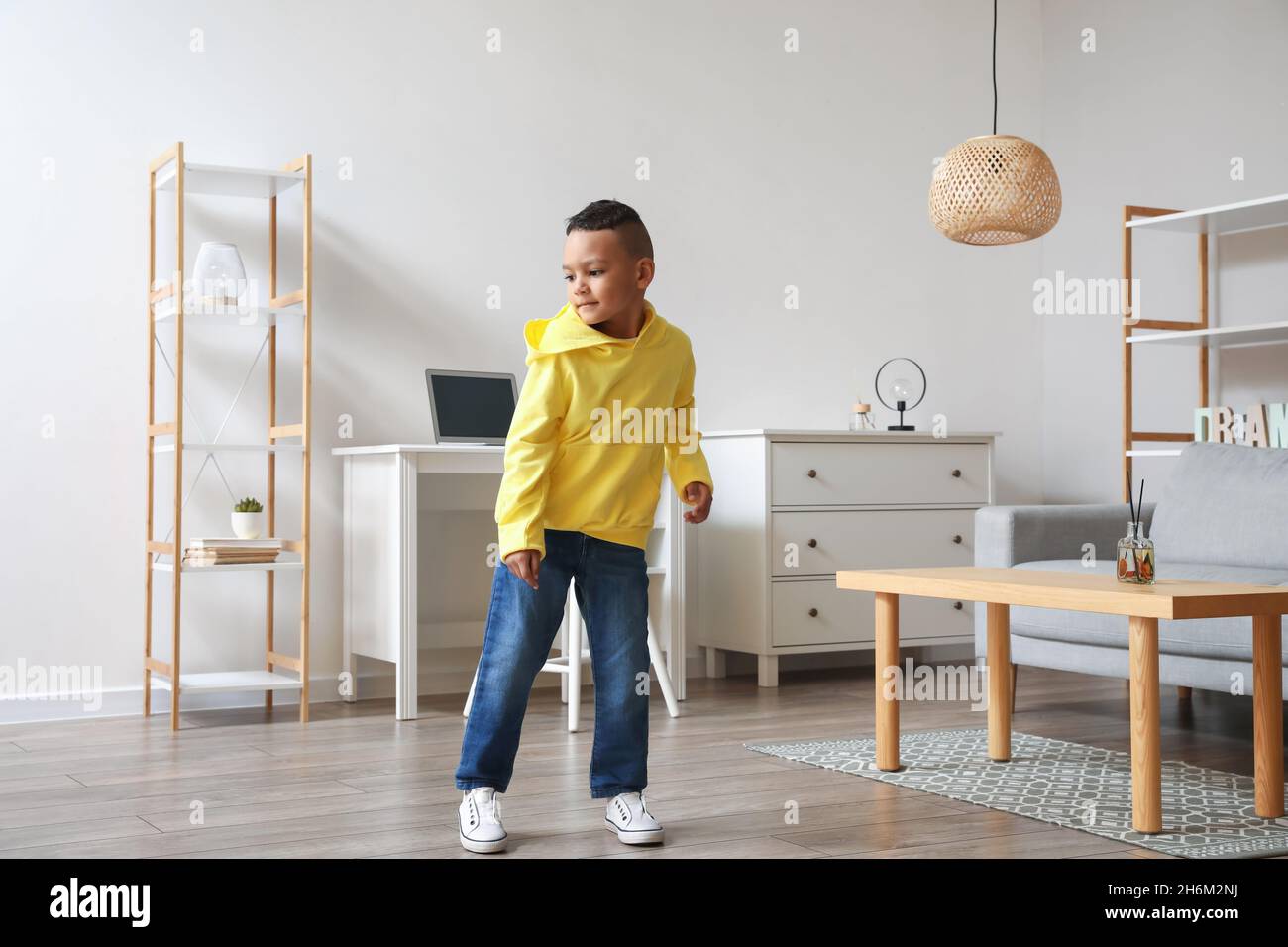 Cute African-American boy dancing at home Stock Photo - Alamy