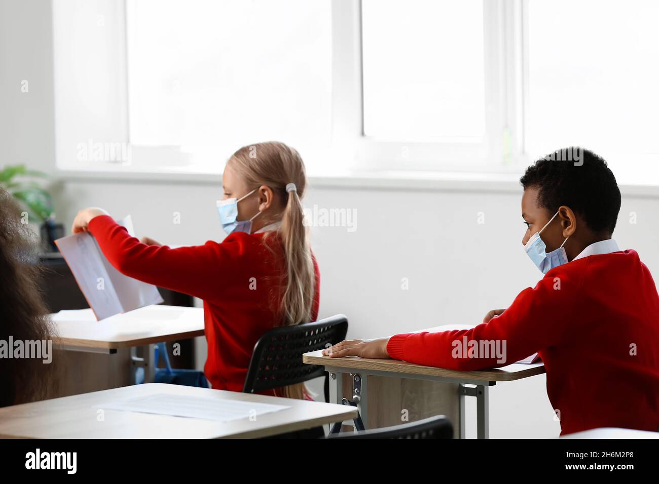 Pupils passing school test in classroom Stock Photo - Alamy