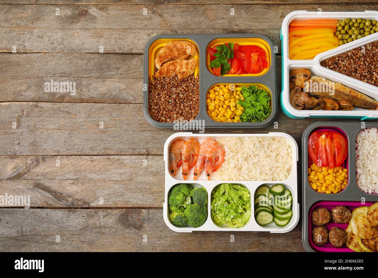 Containers with different tasty food on wooden background Stock Photo ...