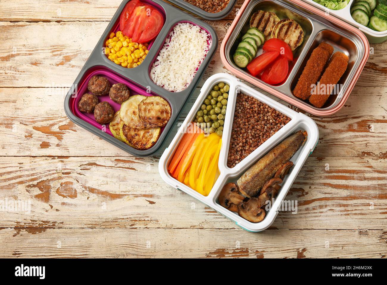 Containers with healthy food on light wooden background Stock Photo - Alamy