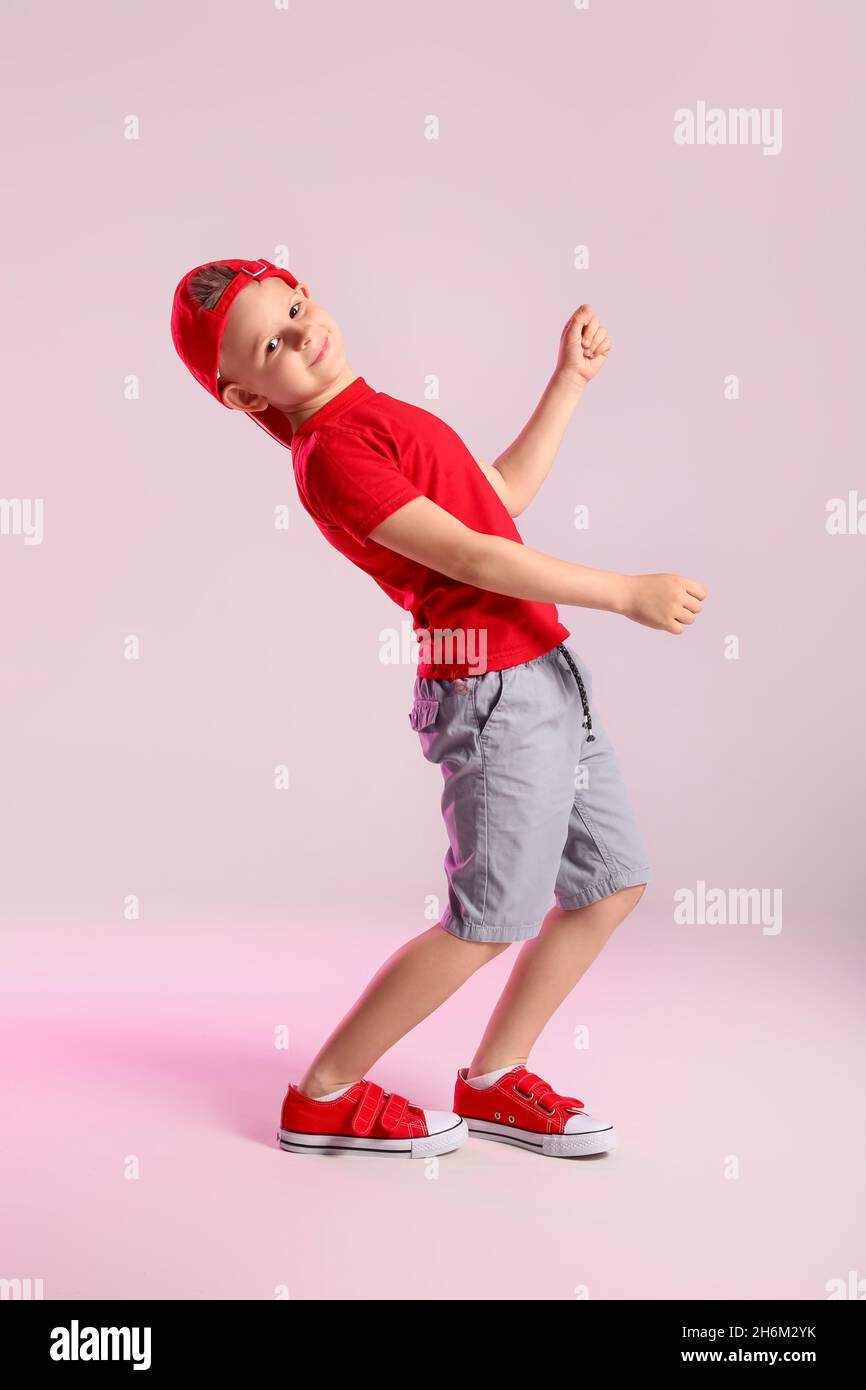 Cute little boy dancing on grey background Stock Photo - Alamy
