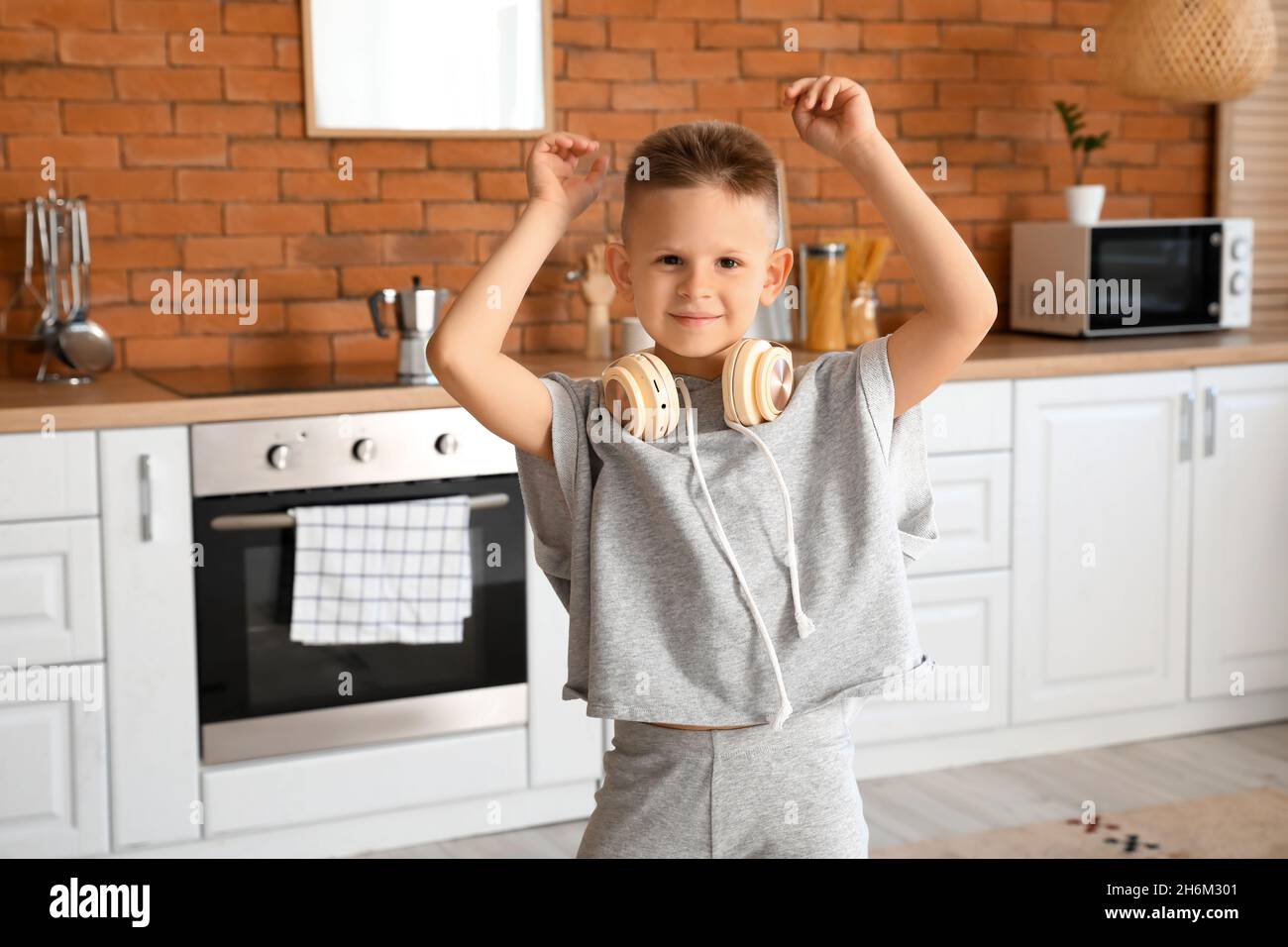 Cute little boy dancing in kitchen Stock Photo - Alamy