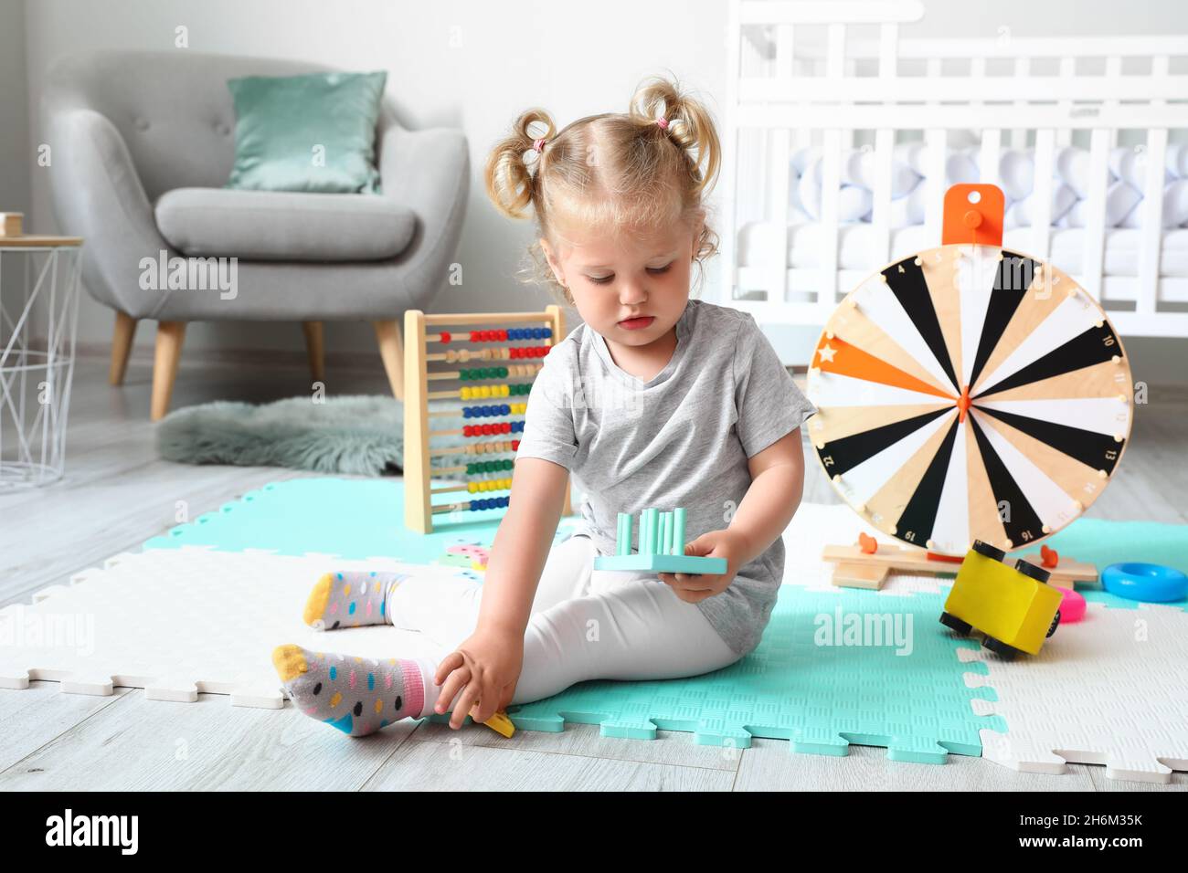 Cute baby girl playing at home Stock Photo - Alamy