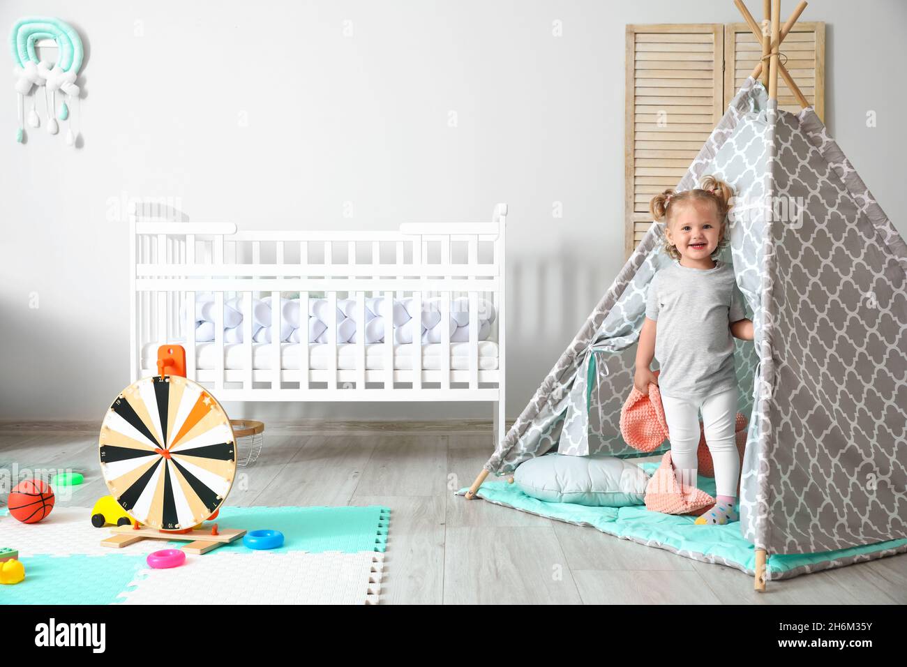 Cute baby girl playing at home Stock Photo - Alamy