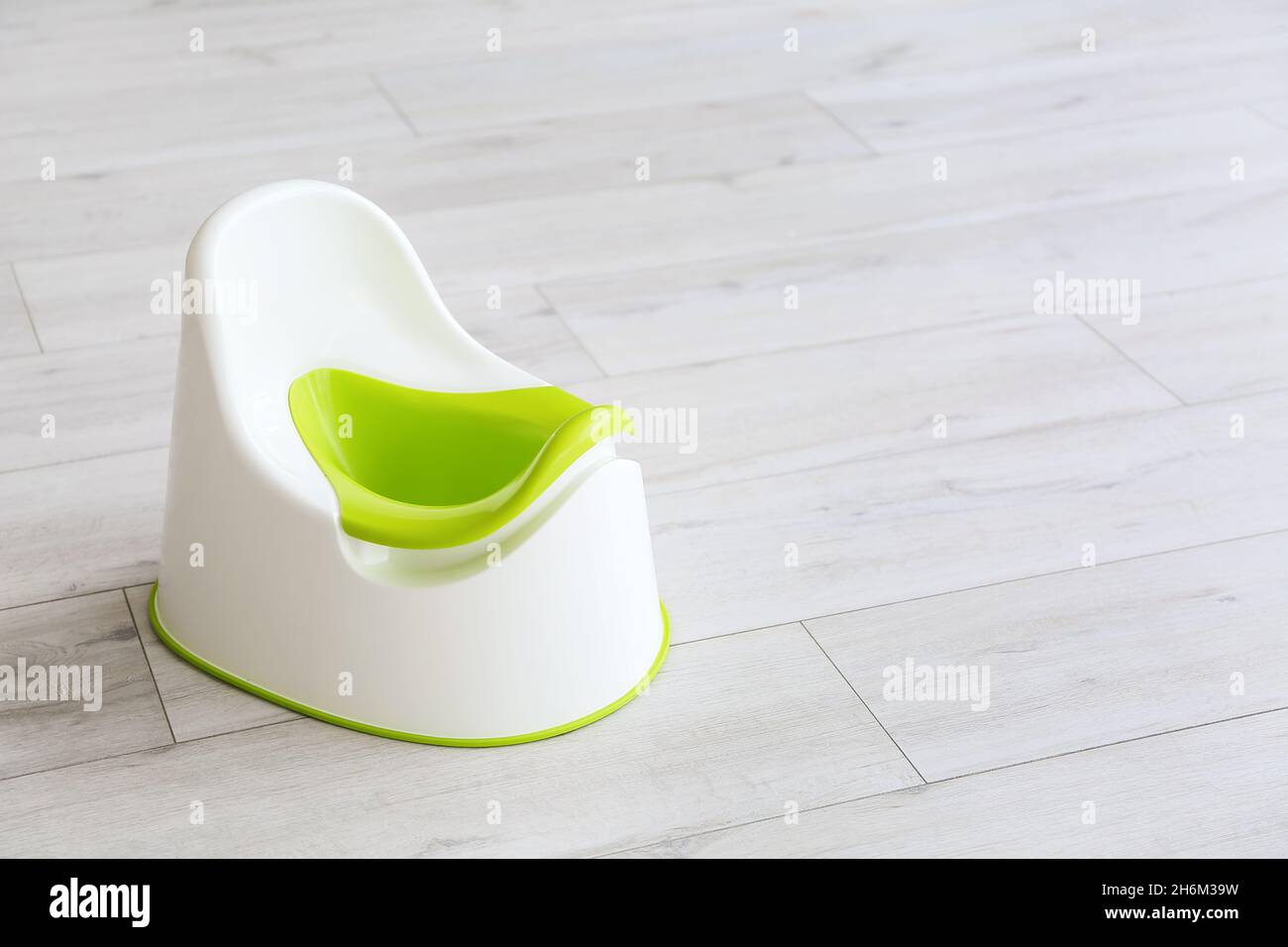 White potty on grey wooden floor Stock Photo - Alamy